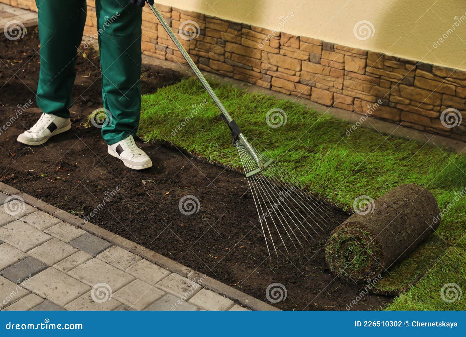Worker Leveling Soil before Laying Grass Sod at Backyard, Closeup Stock ...