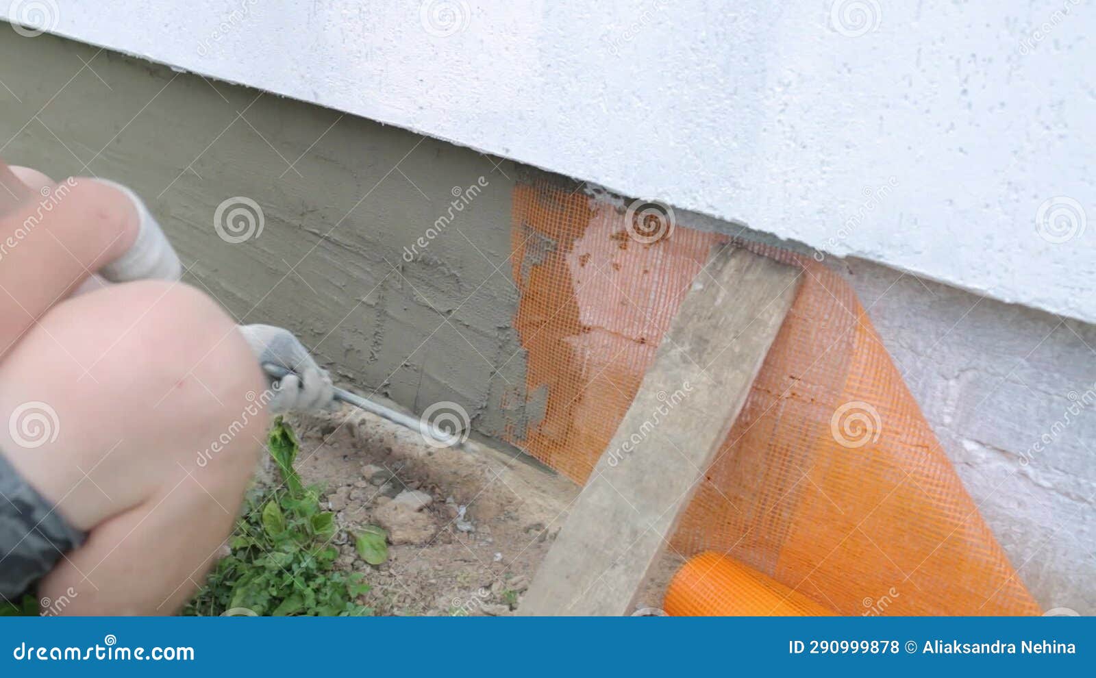 A Worker Levels the Foundation of a House with Cement Plaster ...
