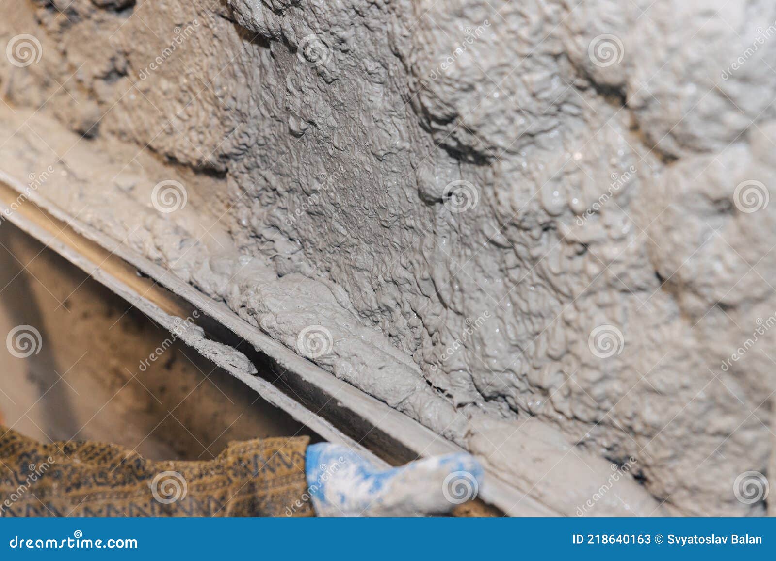 A Worker Levels the Plaster with a Leveler. Stock Image - Image of ...