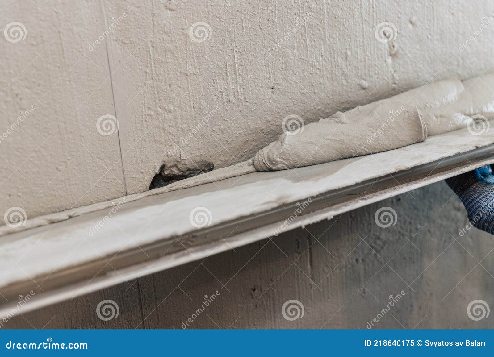 A Worker Levels the Plaster with a Leveler Stock Image - Image of ...