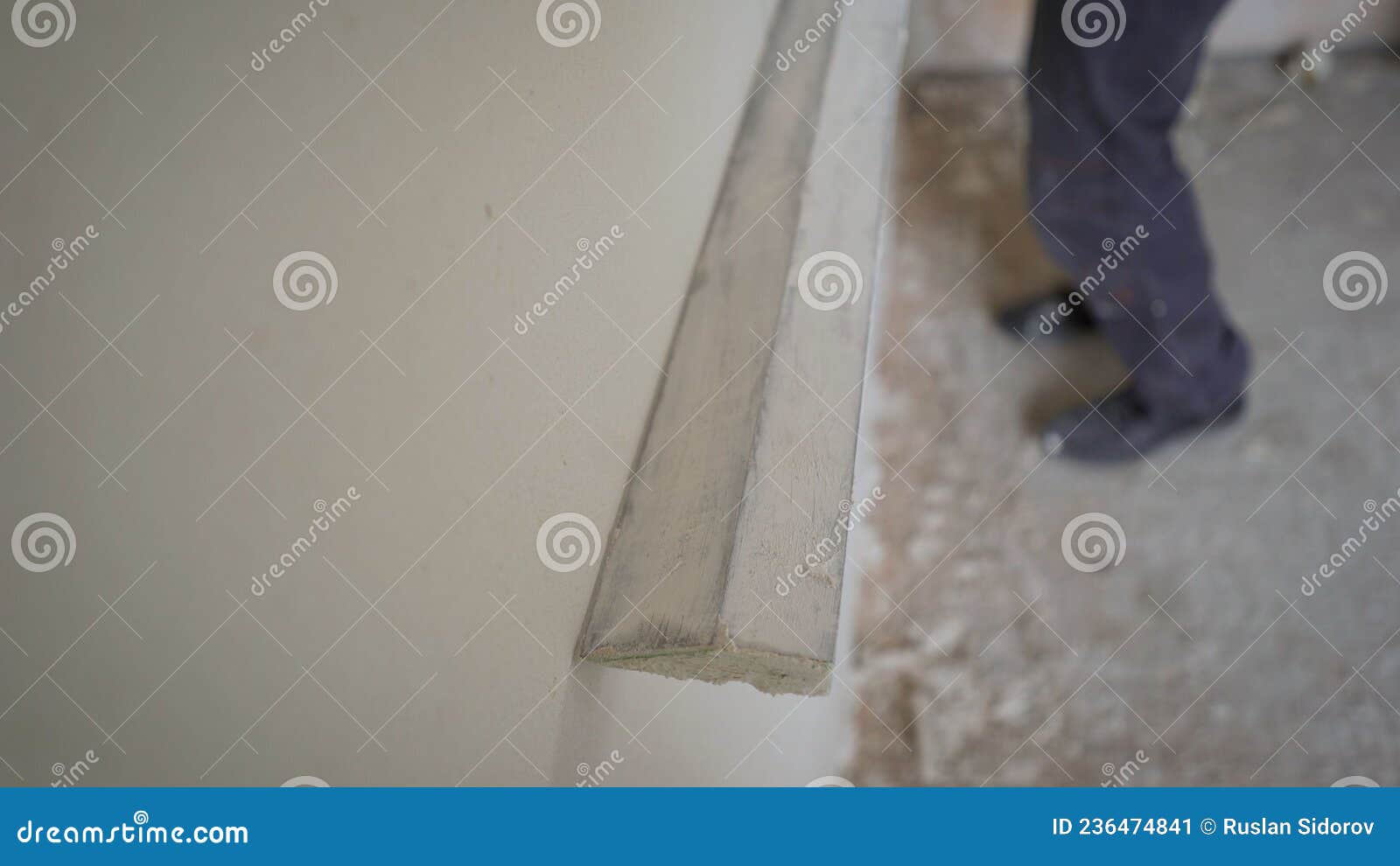 The Process of Leveling Plaster on a Wall Using a Tool. the Worker ...