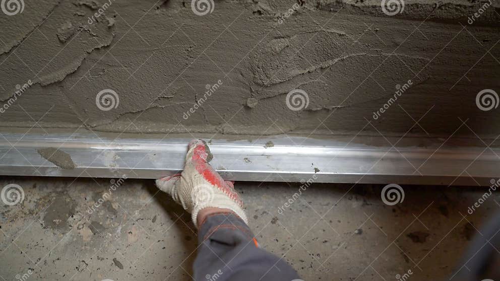 Builder Using Shape Rule for Plastering Brick Wall. the Worker Levels ...