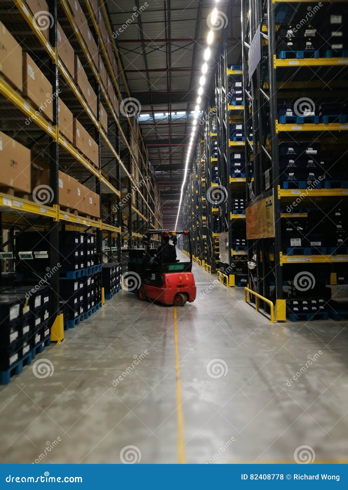Worker Lifting the Goods in To the High Shelf with the Auto Lift ...