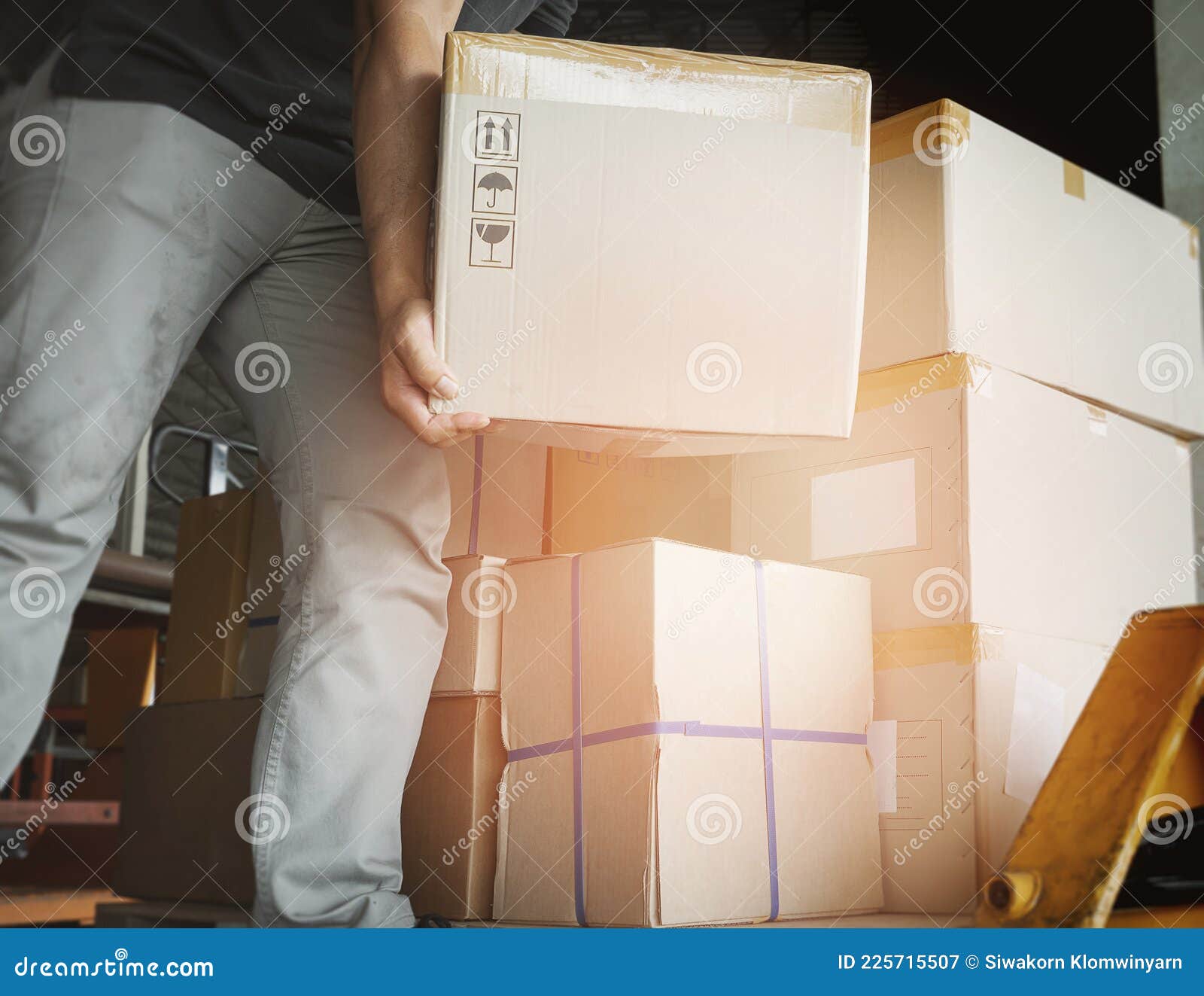 Worker Lifting Package Boxes Stack on Pallet. Shipment Boxes ...