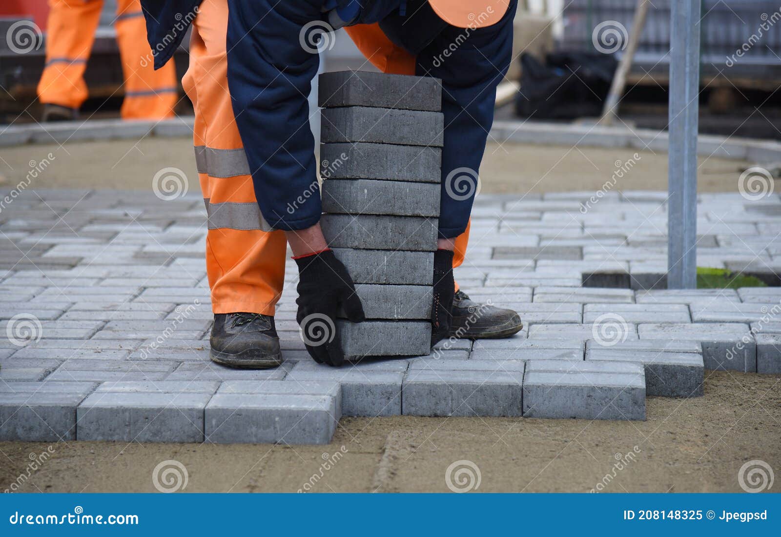 A Worker Lifts a Concrete Paving Slab. Stock Image - Image of brick ...