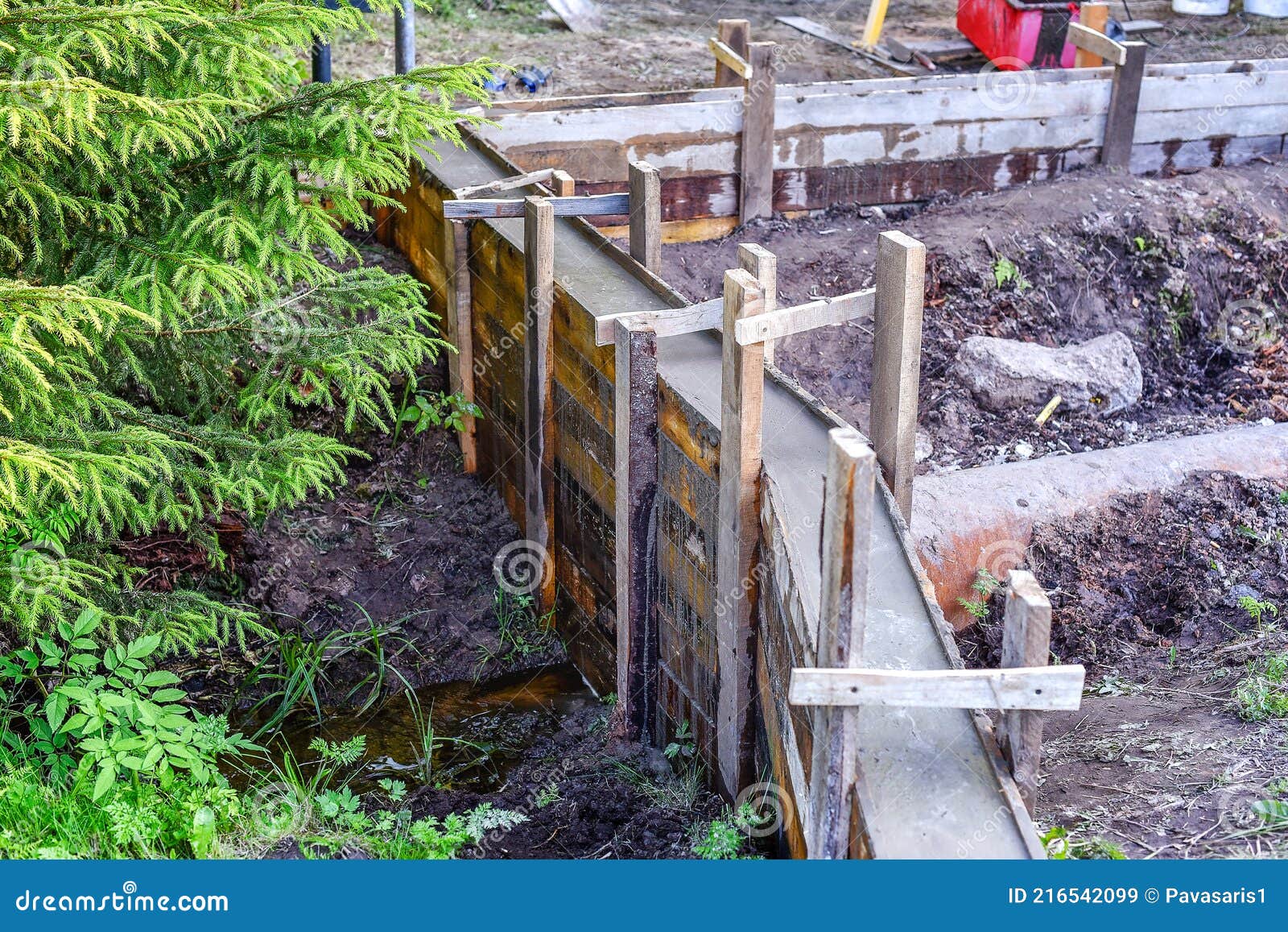 Worker Lines Concrete in Formwork with Trowel, Construction of New Home ...
