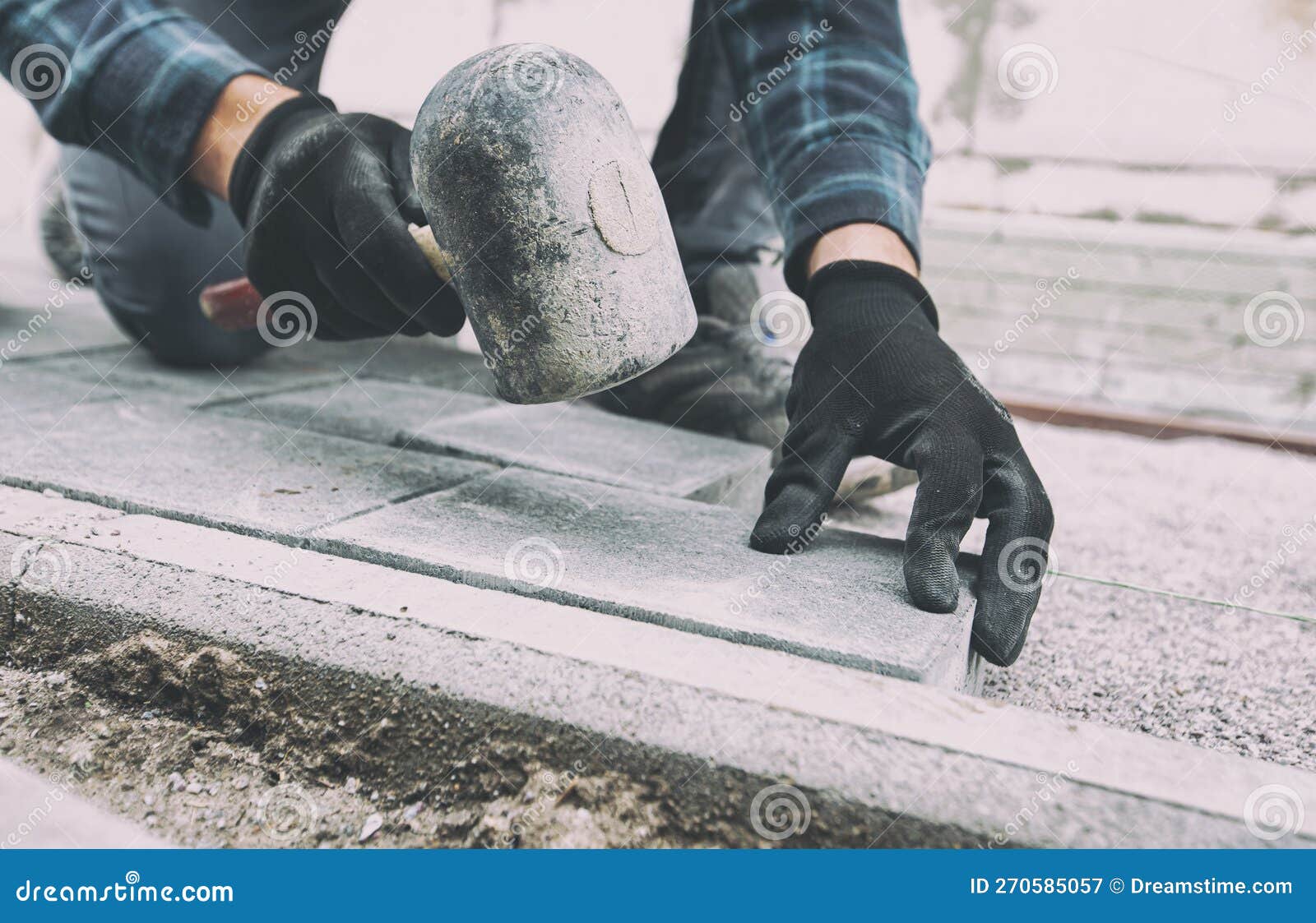 Worker lining paving slabs stock image. Image of hand - 270585057
