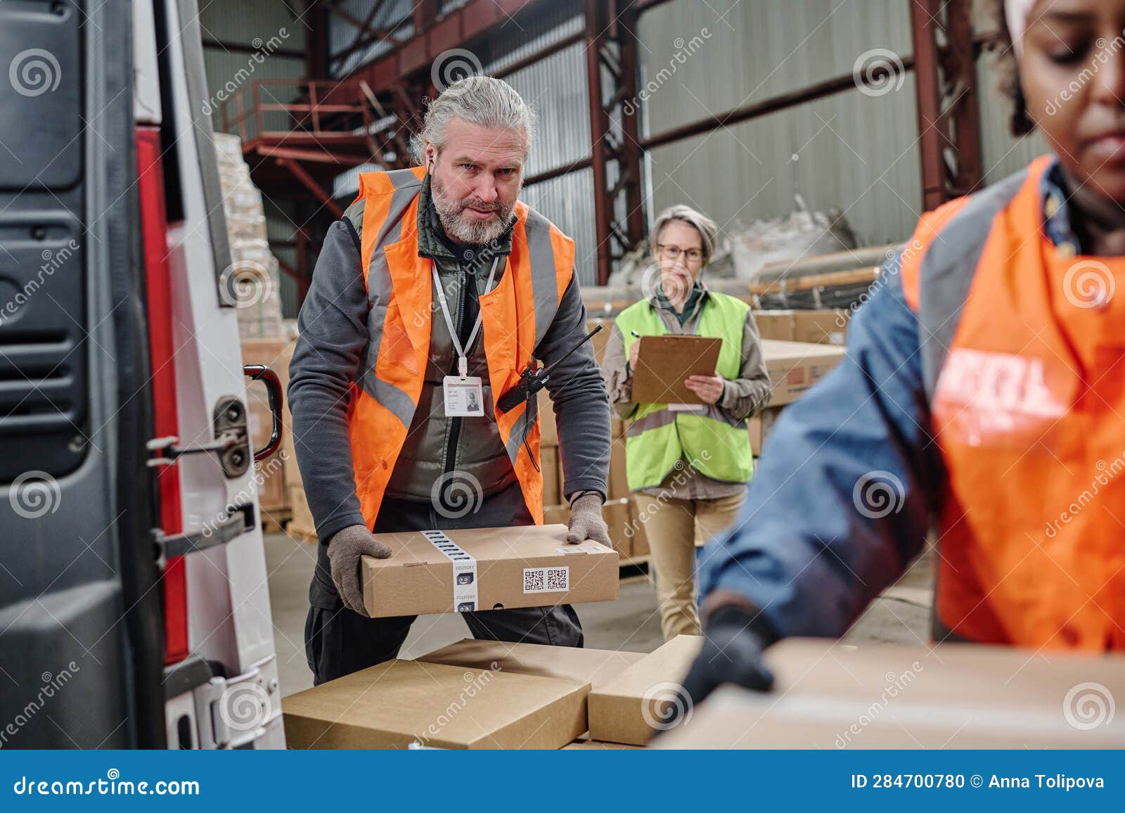Worker Loading Boxes with His Colleagues Stock Photo - Image of ...