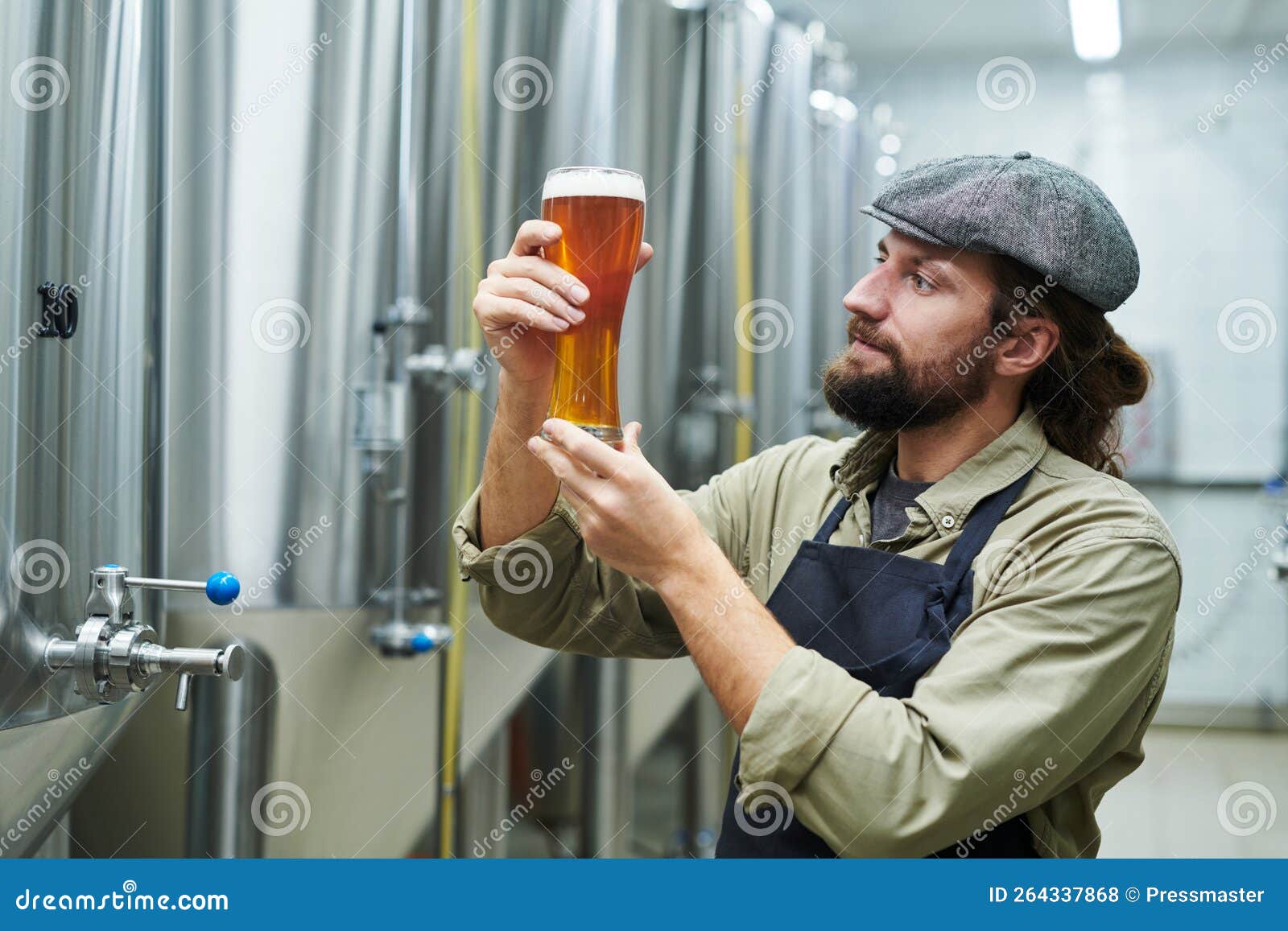 Worker Looking at Glass of Beer Stock Photo - Image of business, apron ...