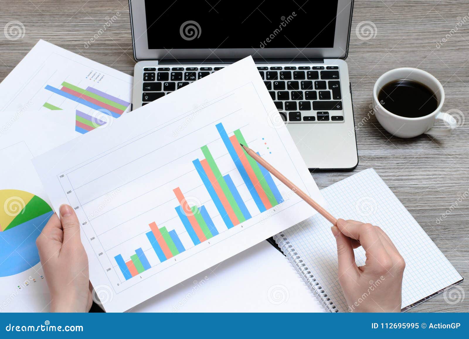 Worker Looking at Graphics. Top View on Hands Holding Graphs, Laptop ...