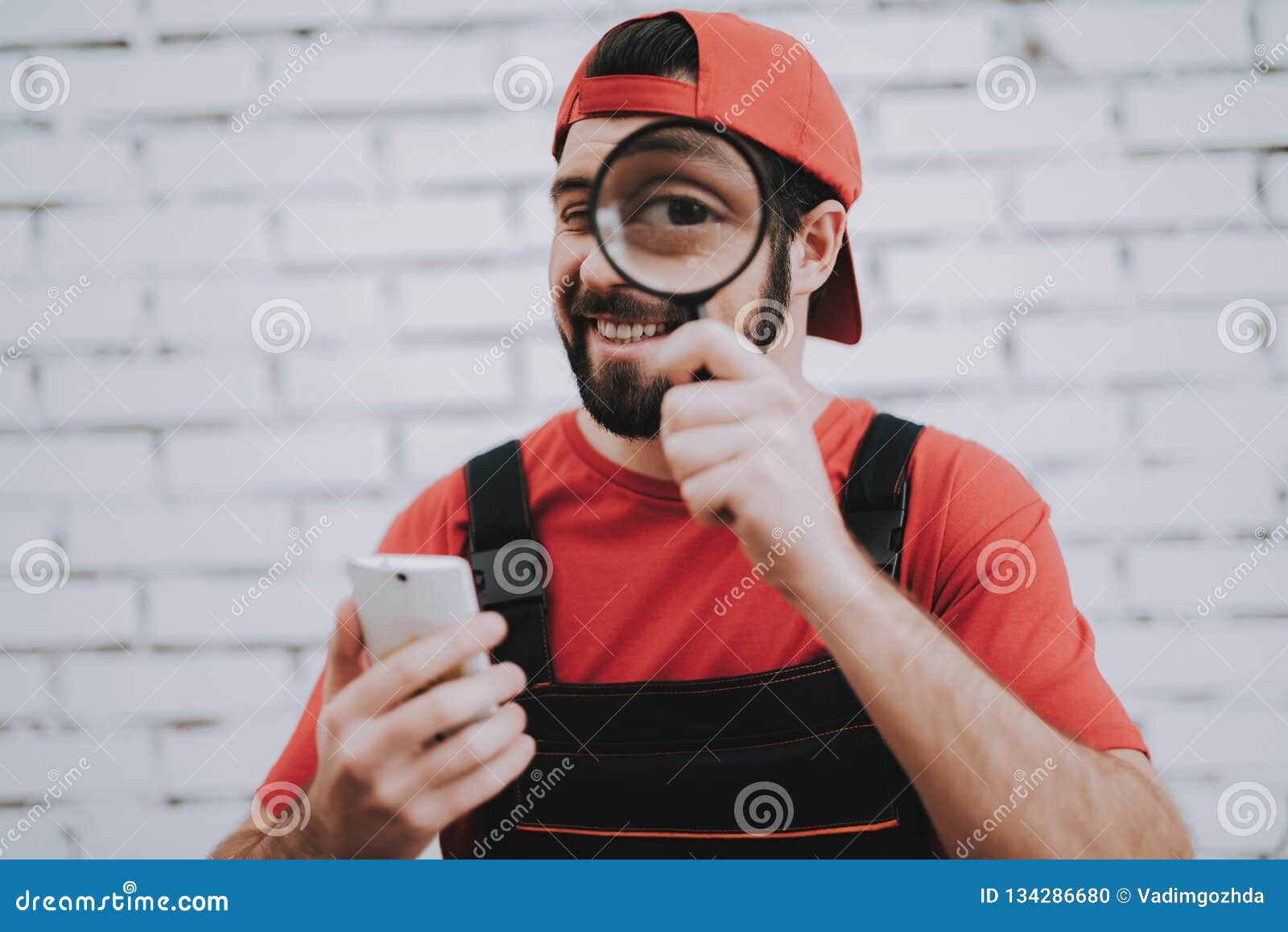 Worker with Magnifying Glass and Mobile Phone. Stock Photo - Image of ...