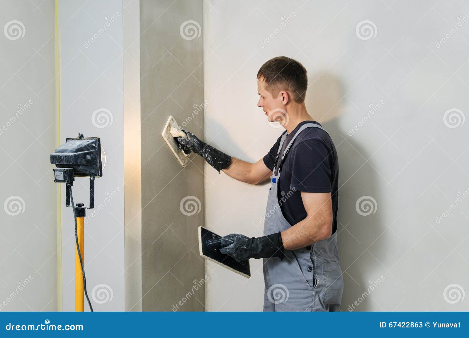 Worker Makes Final Smoothing Plaster on the Wall. Stock Image - Image ...