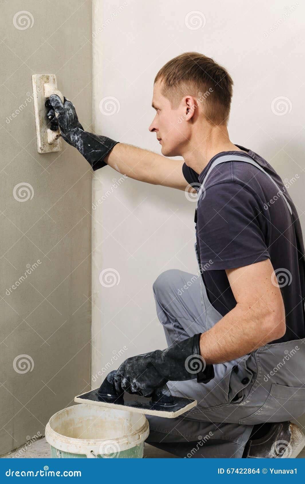 Worker Makes Final Smoothing Plaster on the Wall. Stock Photo - Image ...
