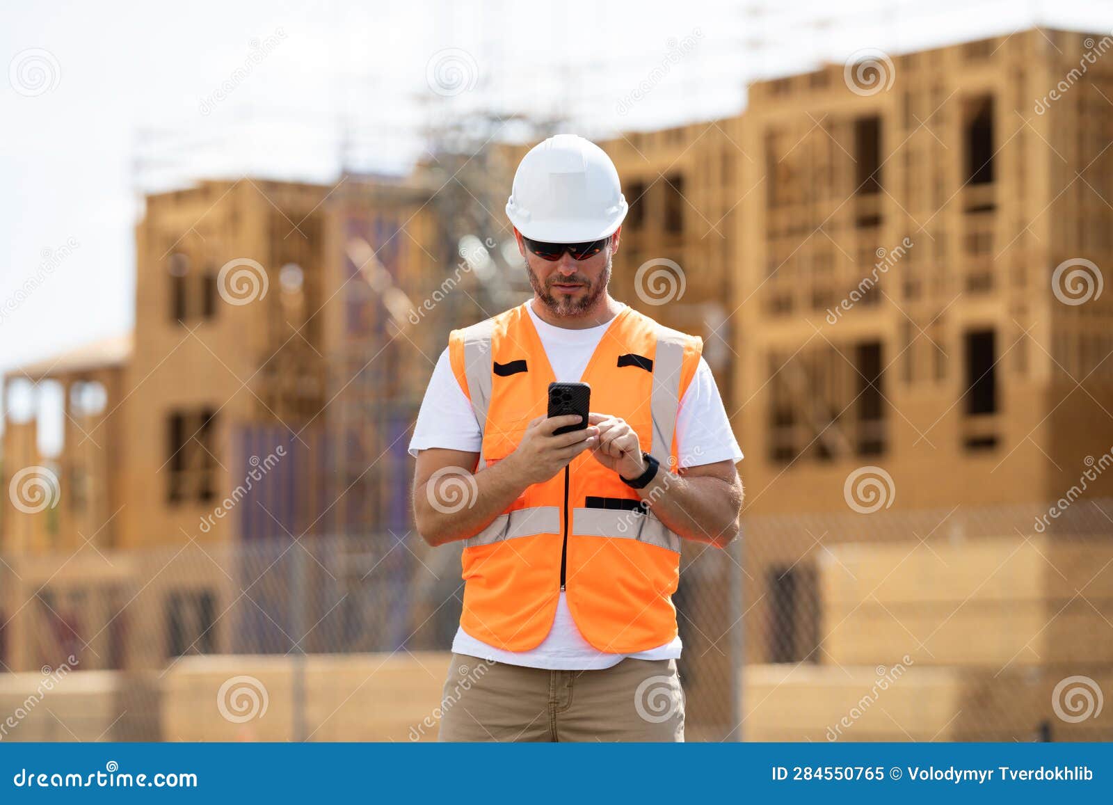 Worker Man on the Building Construction. Worker Using Phone, Builder ...