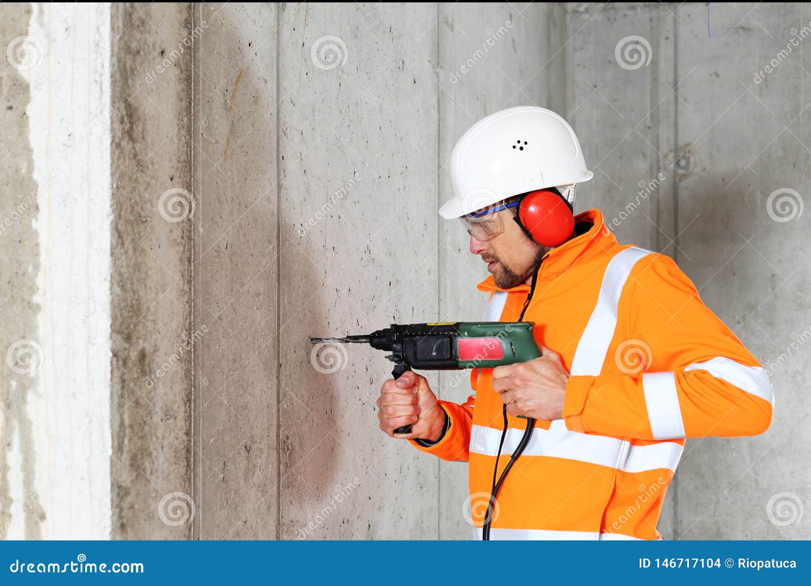 Worker Man Drilling in Concrete on a Construction Site Stock Photo ...