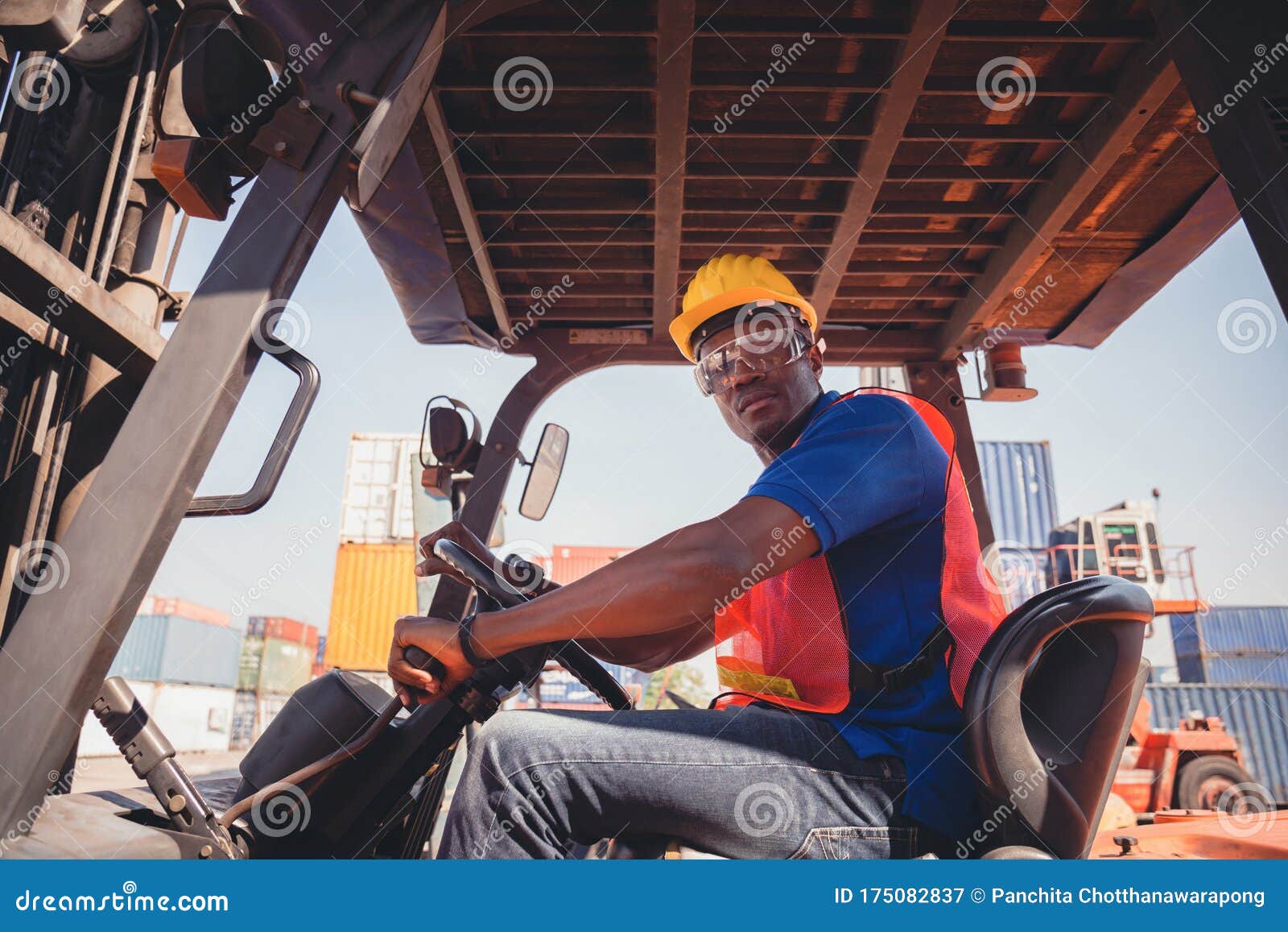 Worker Man in Hardhat and Safety Vest Sitting in Container Stackers ...