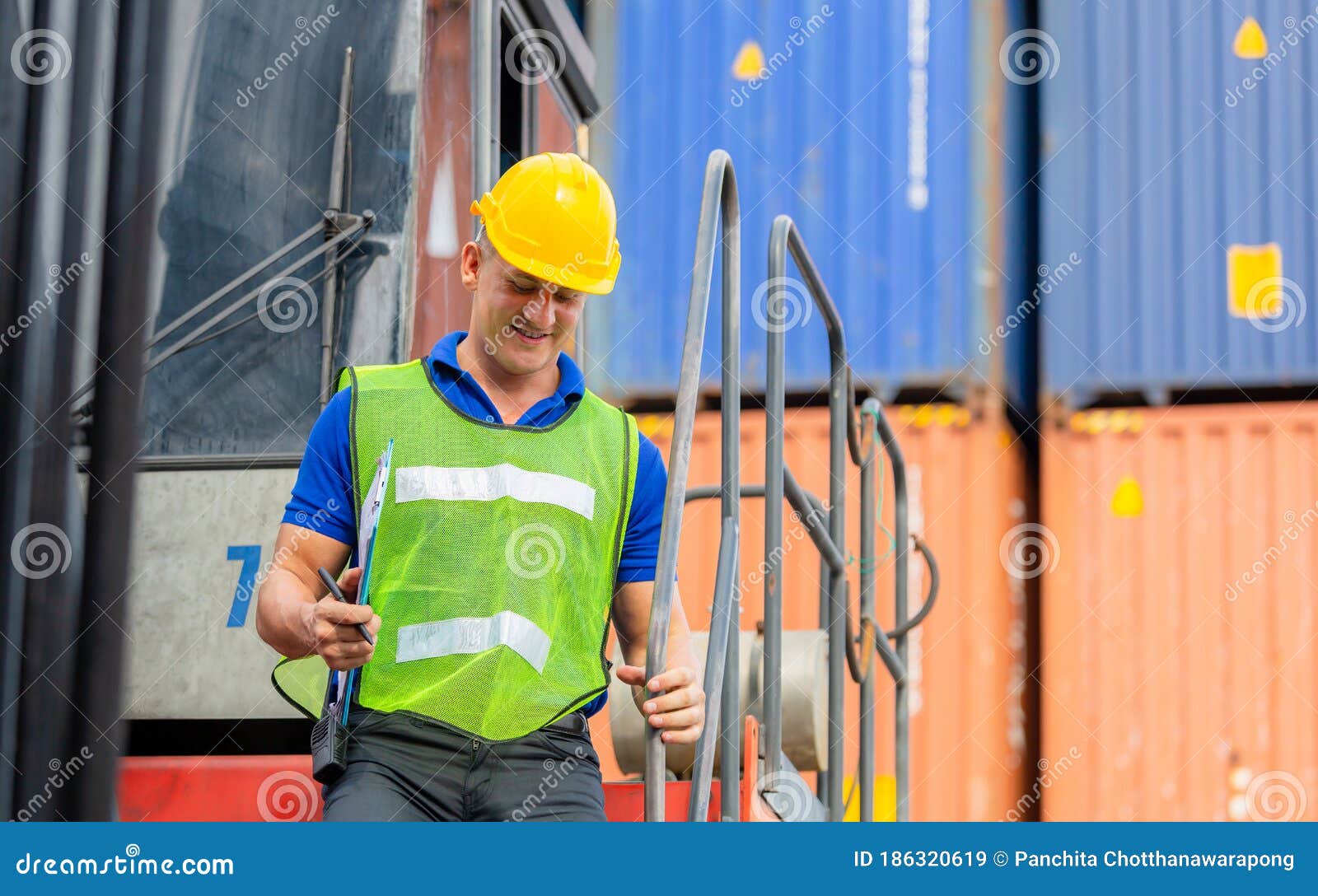 Worker Man in Hardhat and Safety Vest Standing on Container Stackers ...