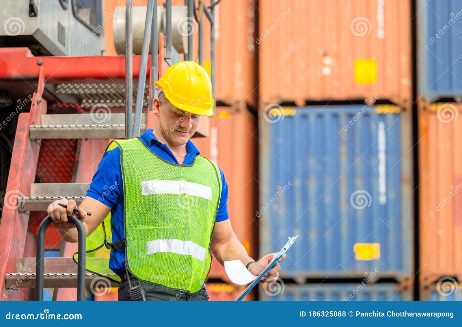 Worker Man in Hardhat and Safety Vest Standing on Container Stackers ...