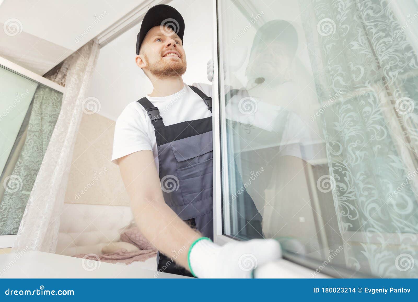 Worker Man Installs Plastic Windows and Doors with Double-glazed White ...