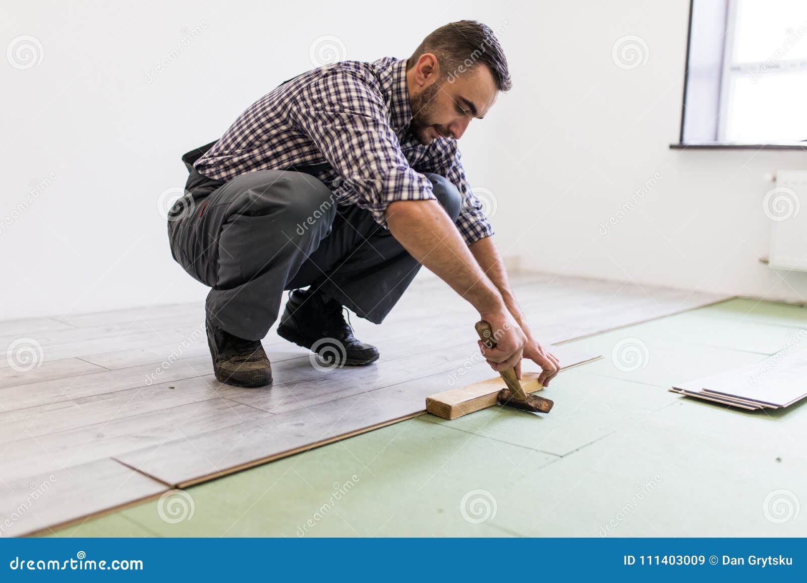 Worker Man Laying Laminate Flooring in Construction Concept Stock Image ...