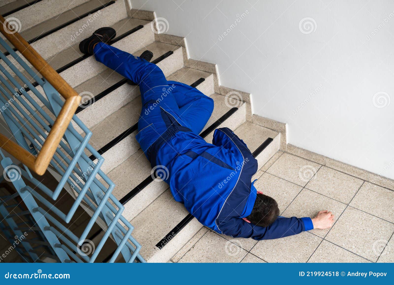Worker Man Lying on Staircase after Slip Stock Photo - Image of back ...