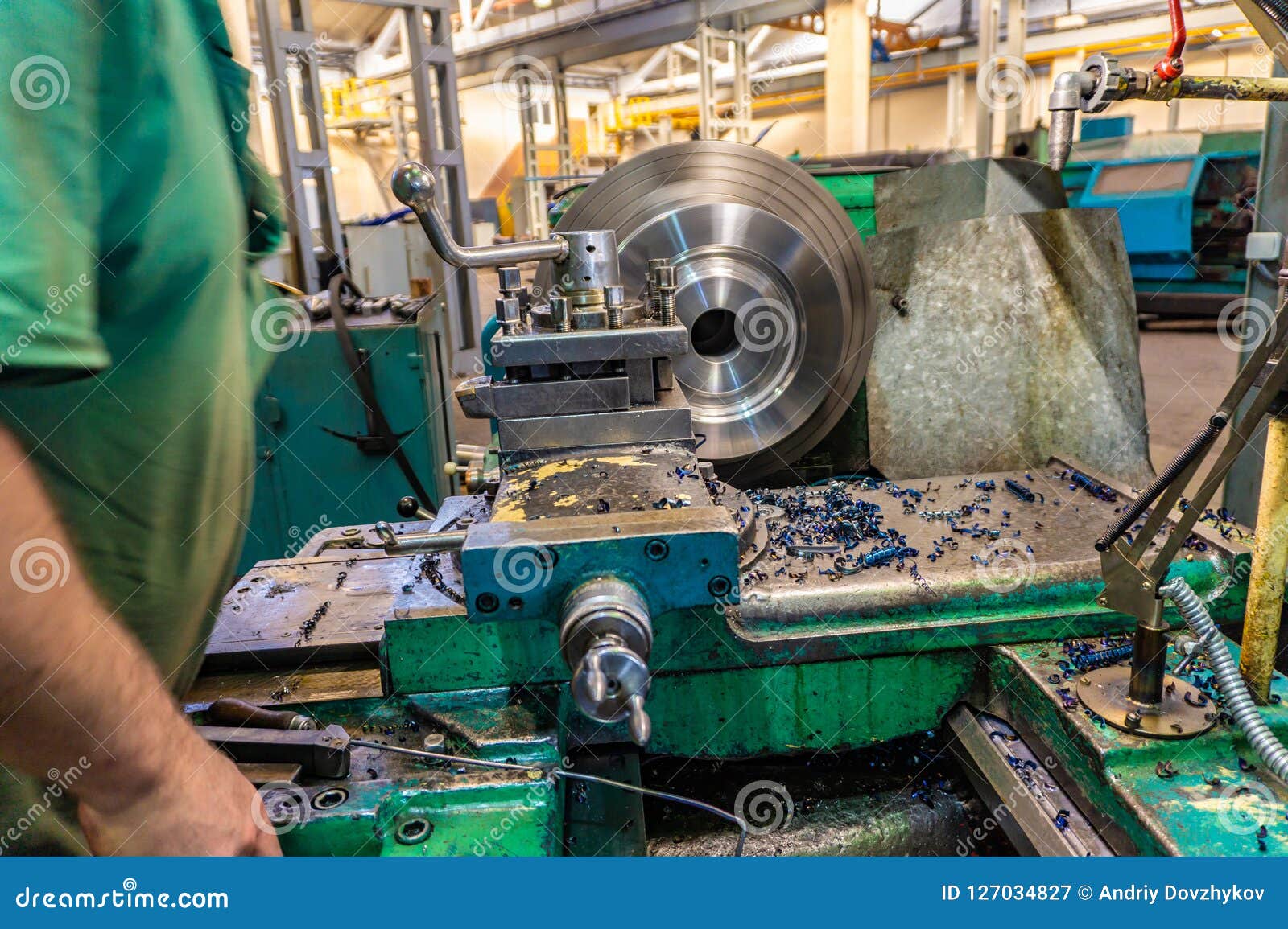 Worker, a Man Processes Metal Products on a Machine. Turning Work in ...