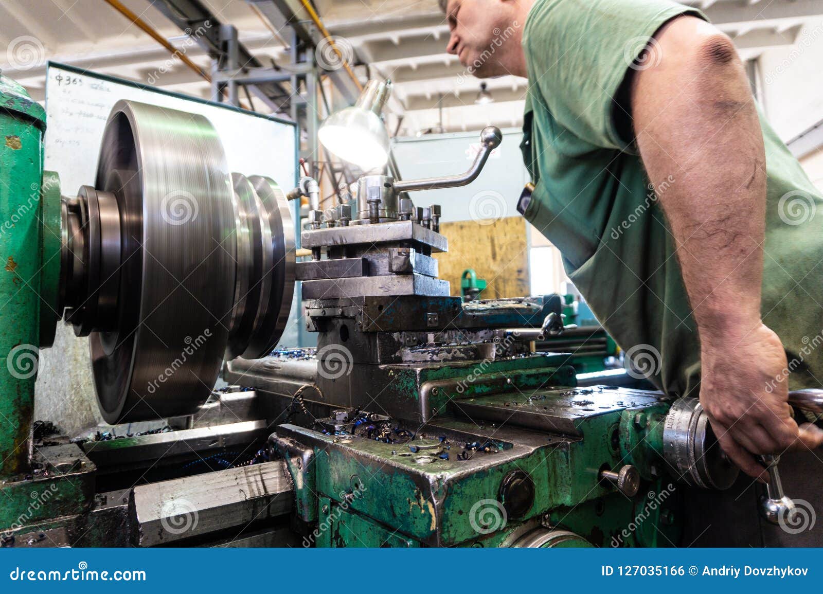 Worker, a Man Processes Metal Products on a Machine. Turning Work in ...