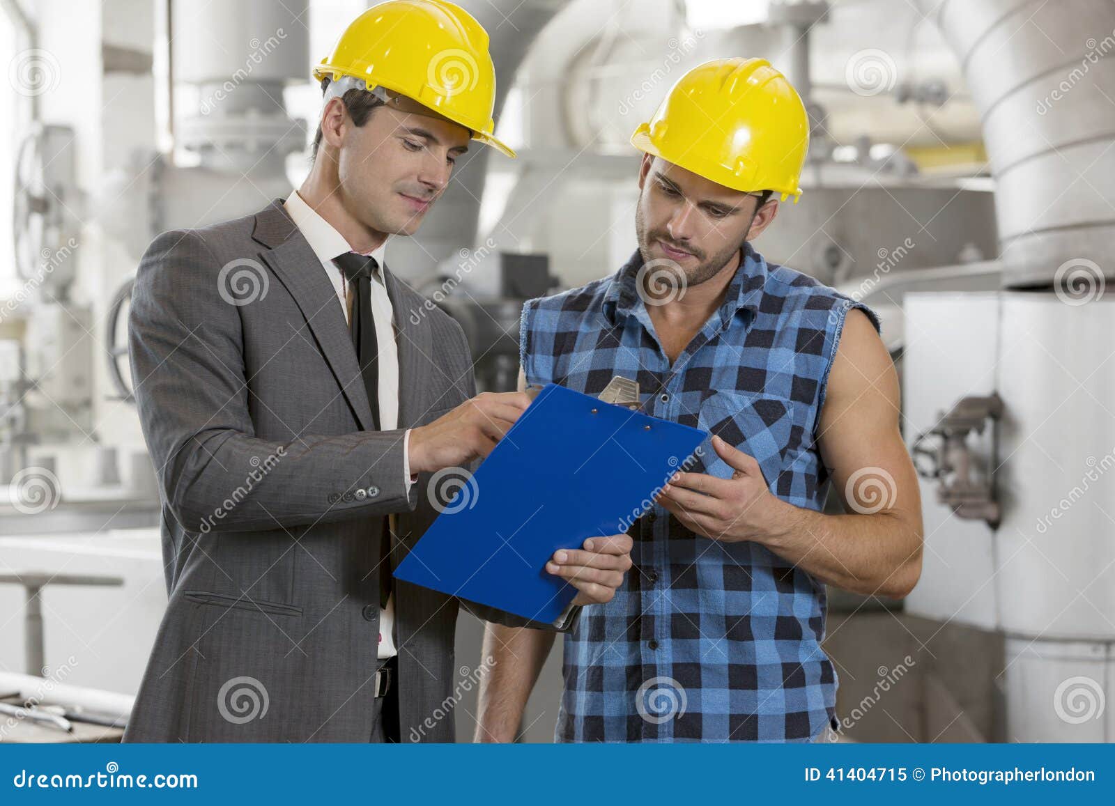 Worker with Manager Discussing Over Clipboard in Industry Stock Image ...