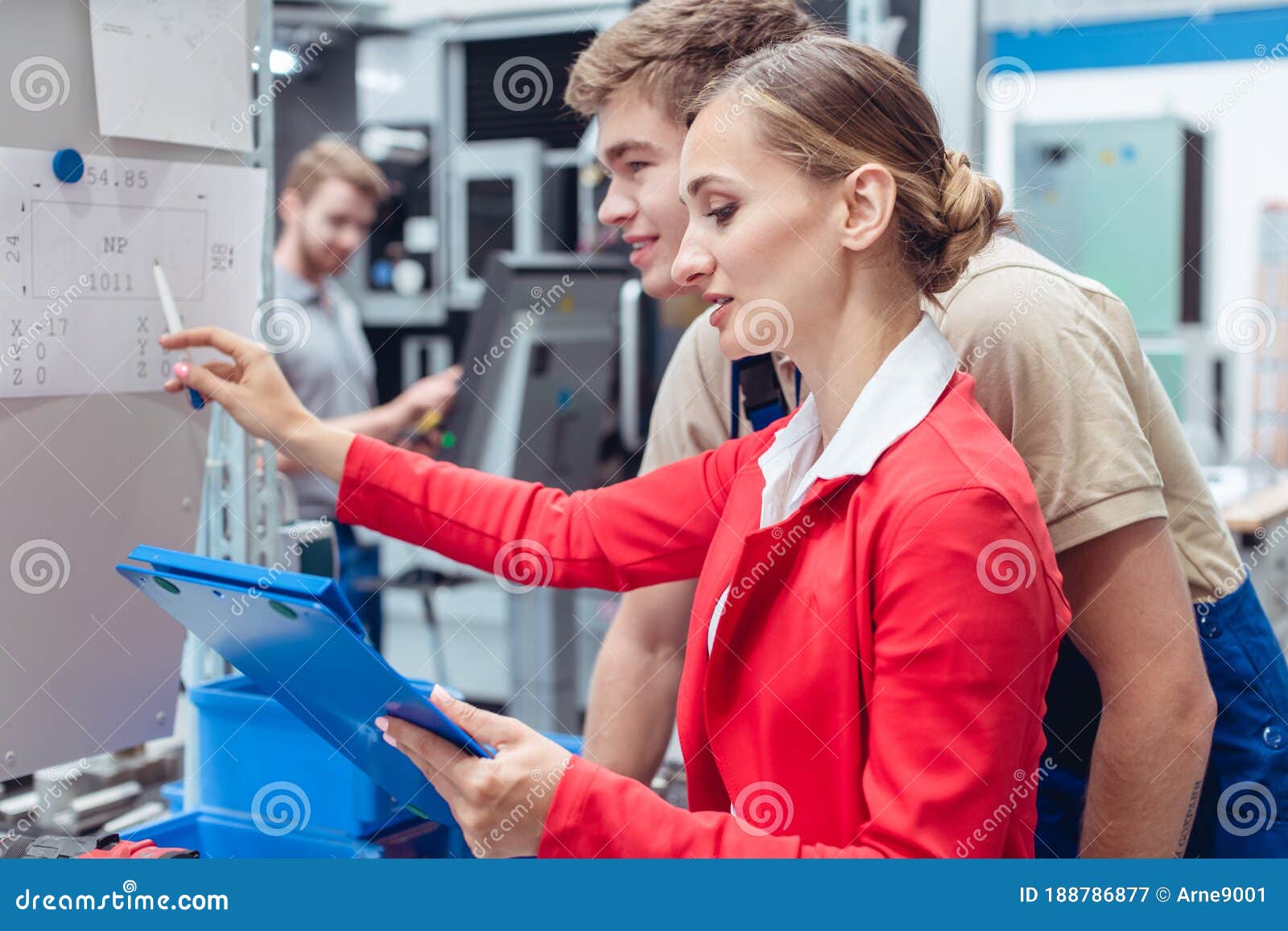 Worker and Manager on Factory Floor Discussing Product Specifications ...