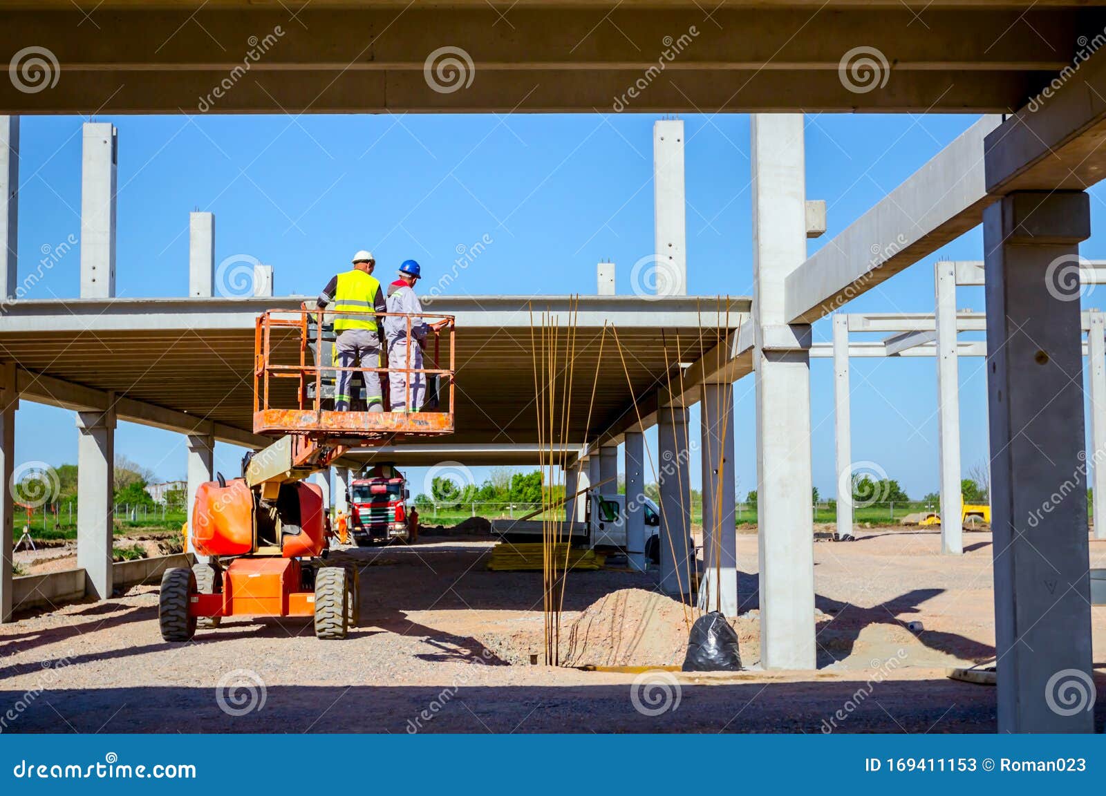 Worker is Managing an Elevated Cherry Picker at Building Site Stock ...