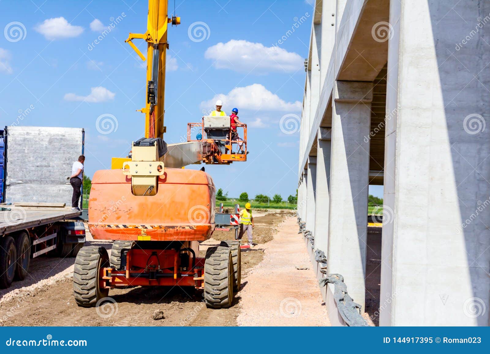 Worker is Managing an Elevated Cherry Picker at Building Site Editorial ...