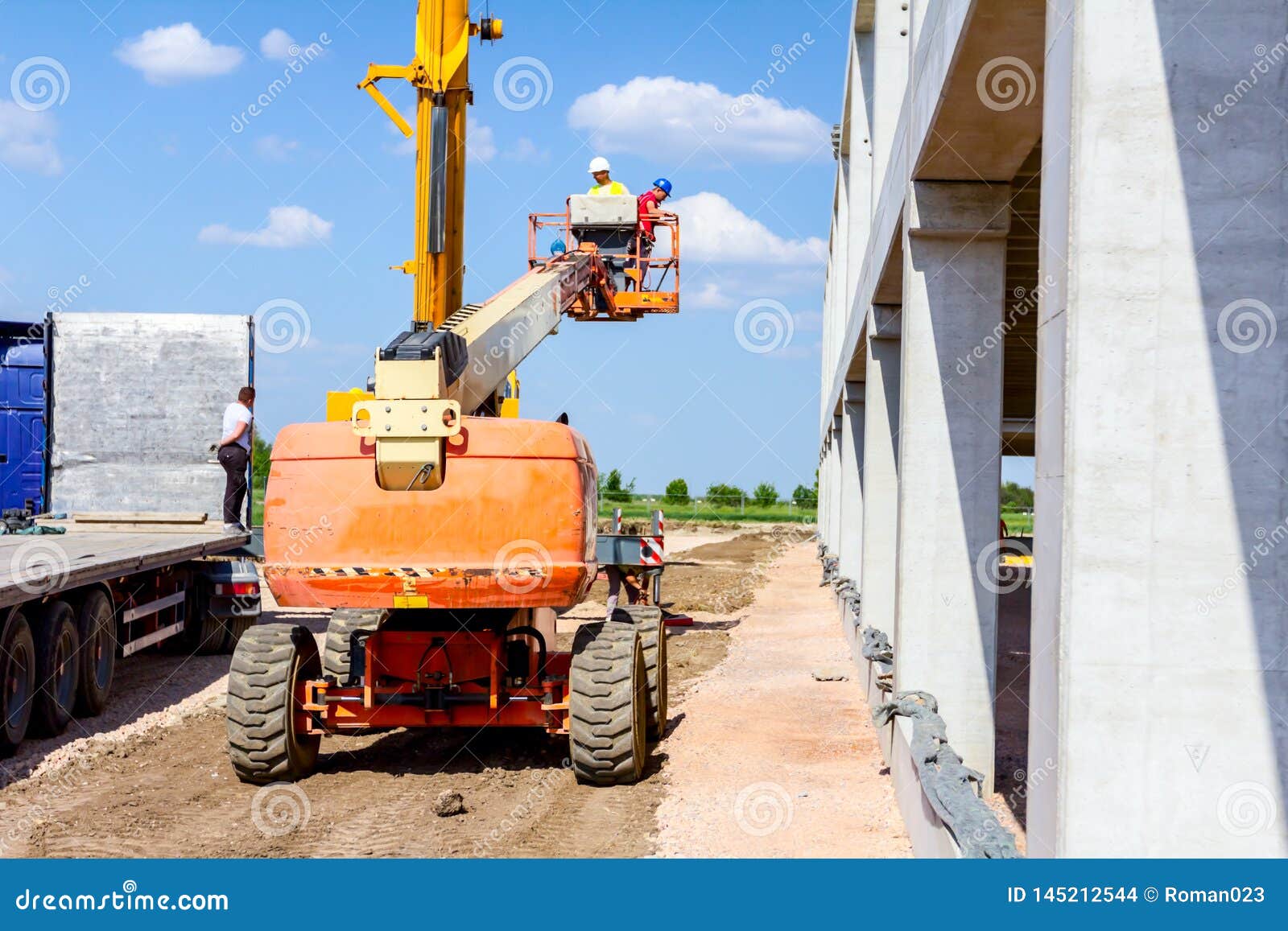 Worker is Managing an Elevated Cherry Picker at Building Site Editorial ...