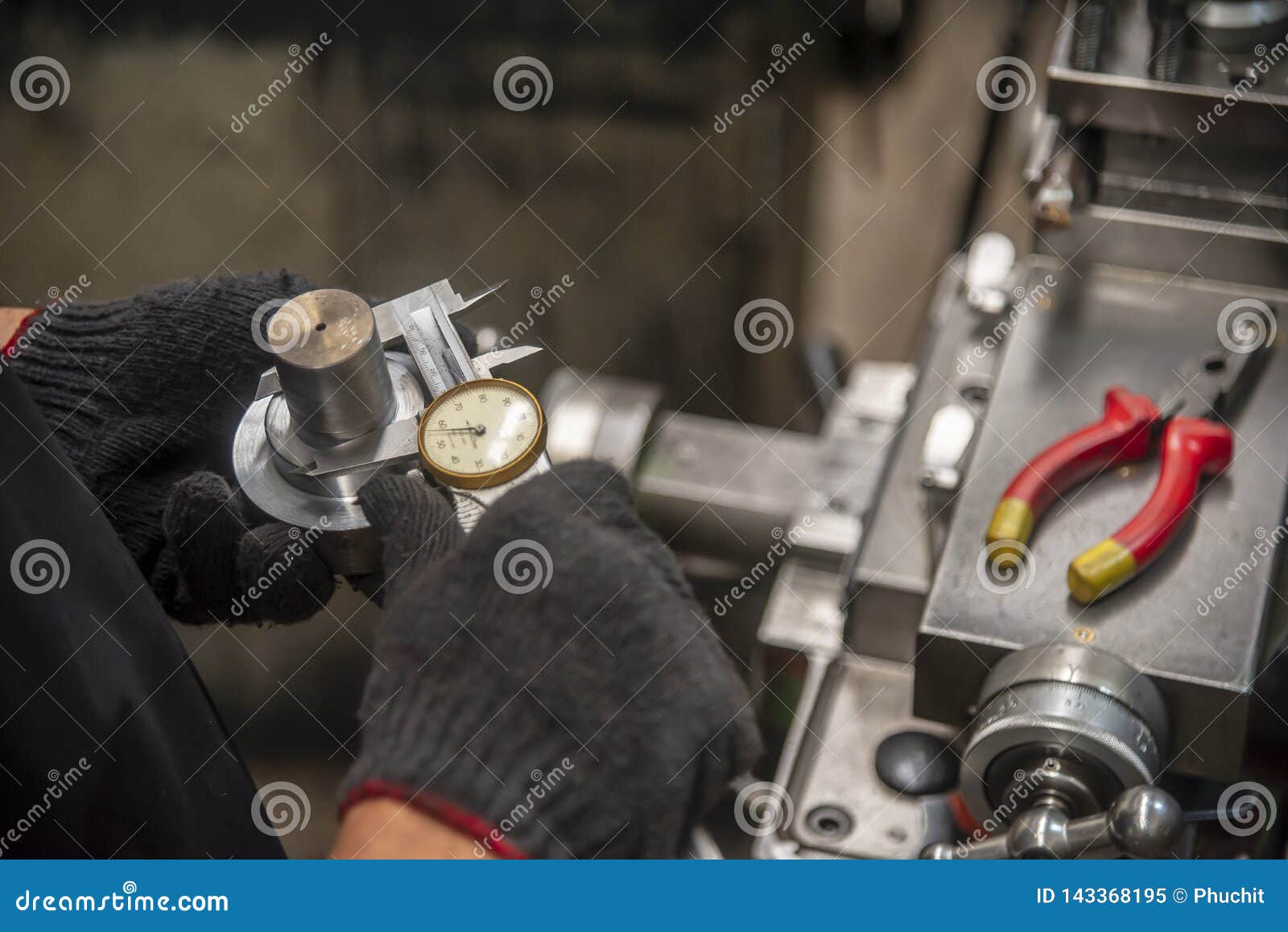 The Worker Measure the Shaft Dimension by the Dial Vernier Calliper ...