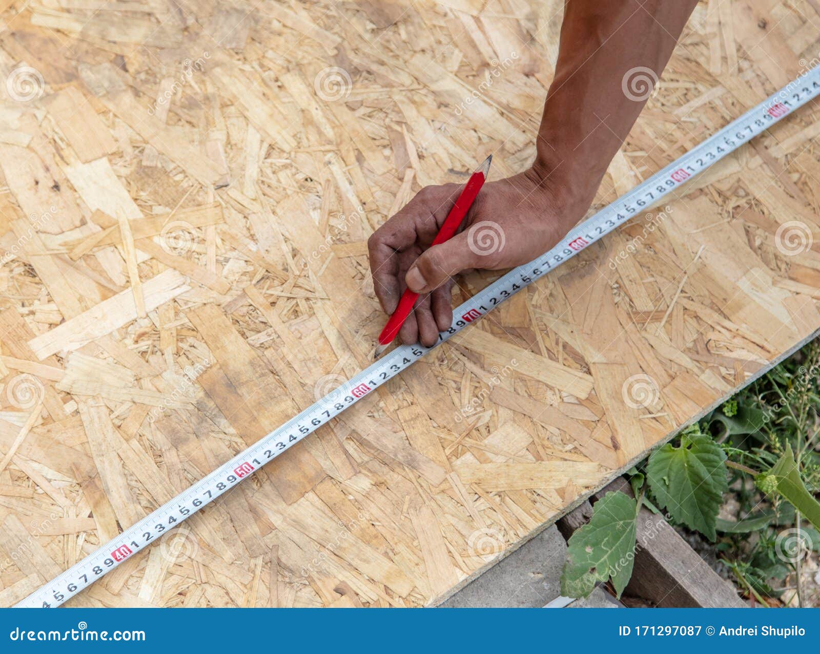Worker Measures the Board at a Construction Site Stock Image - Image of ...
