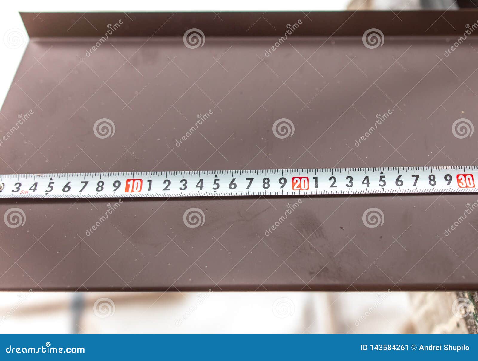 A Worker Measures Metal at a Construction Site with a Meter Stock Image ...