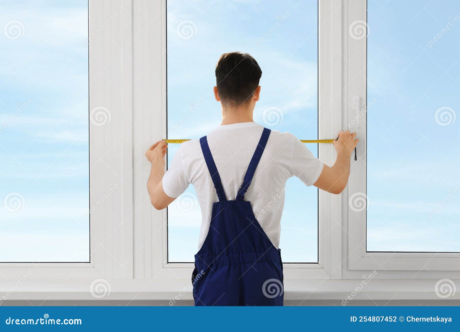 Worker Measuring Plastic Window, Back View. Installation Process Stock ...