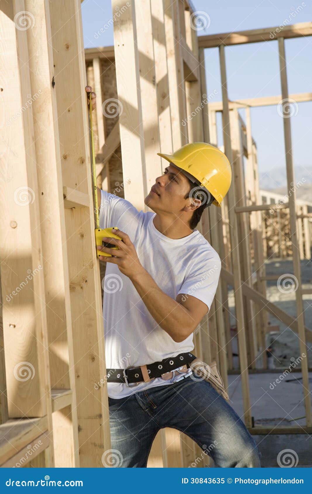 Worker Measuring Timber at Construction Site Stock Image - Image of ...