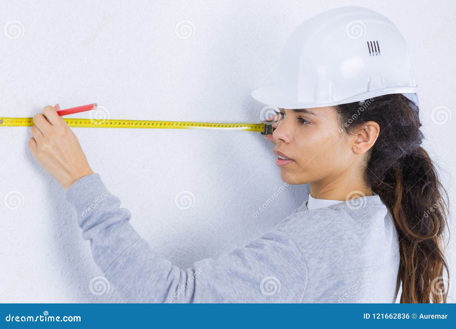 Worker Measuring Wall at Construction Site Stock Photo - Image of white ...
