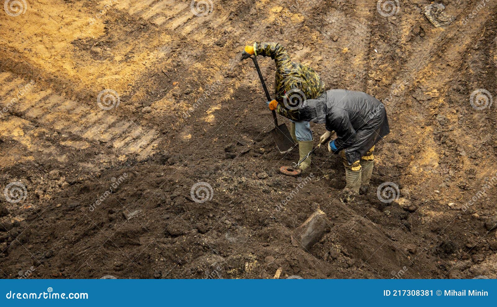A Worker with a Metal Detector is Looking for Valuable Artifacts at an ...