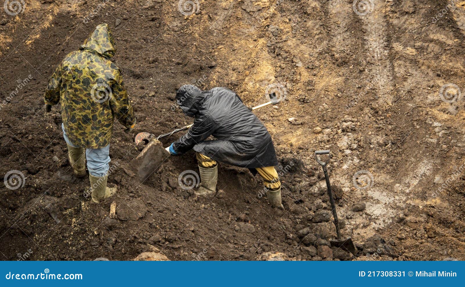 A Worker with a Metal Detector is Looking for Valuable Artifacts at an ...