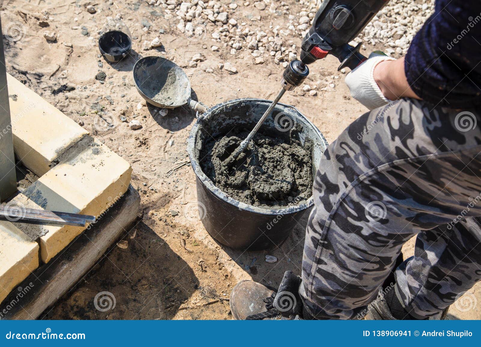 The Worker Mixes the Concrete Mixture at the Construction Site Stock ...