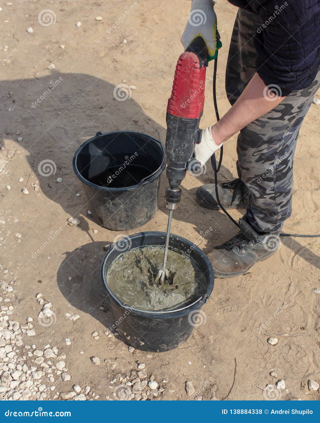 The Worker Mixes the Concrete Mixture at the Construction Site Stock ...