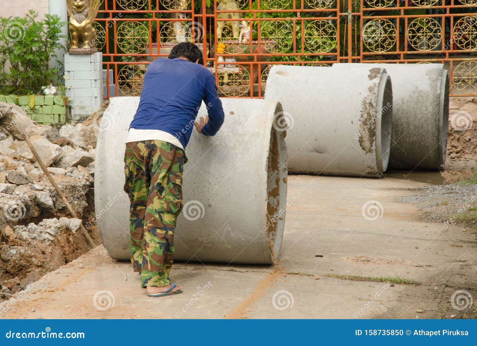 Worker Moves Concrete Pipe by Pushing Editorial Image - Image of pipe ...