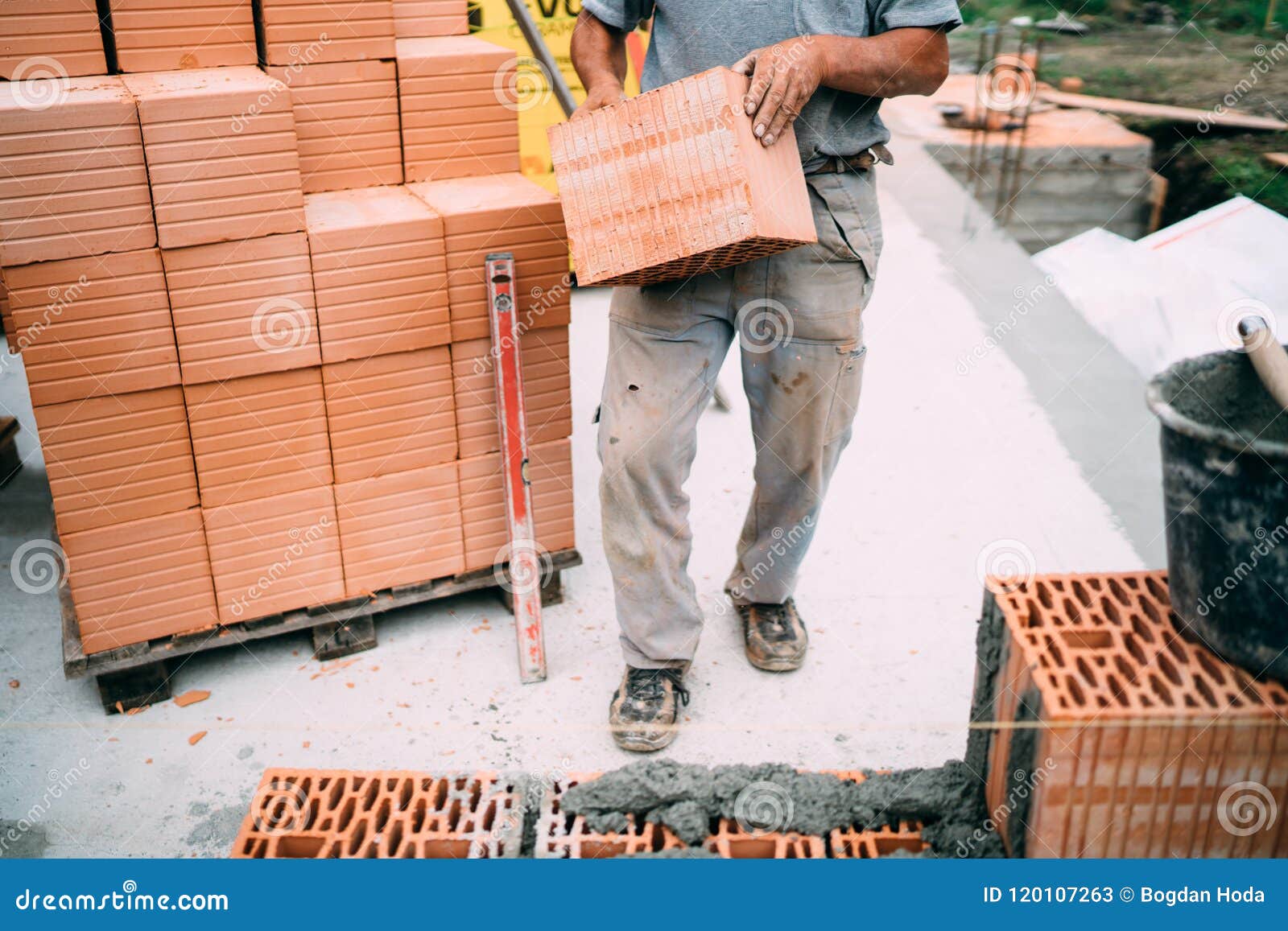 Worker Moving Bricks And Using Tools For Building Exterior Walls With Bricks And Mortar Stock ...