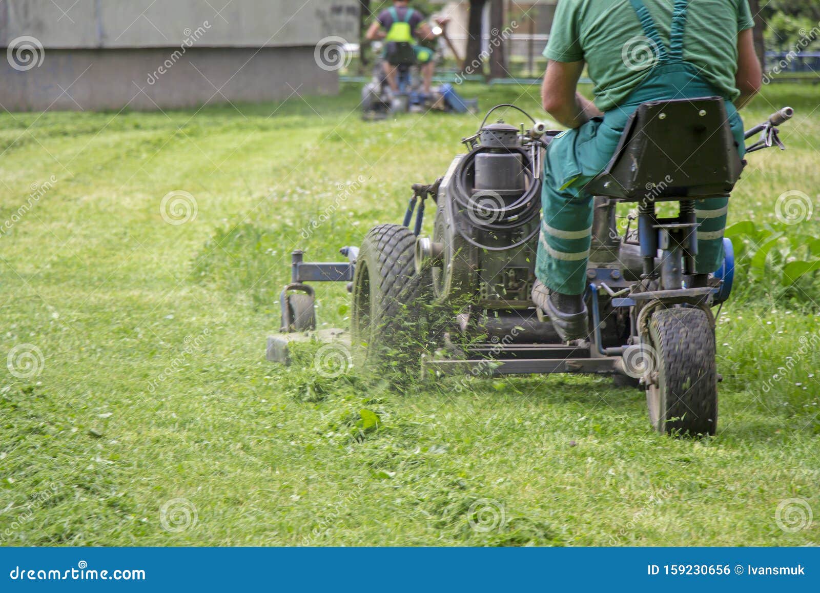 Worker Mowing Grass in City Park Stock Photo - Image of ground, lawn ...