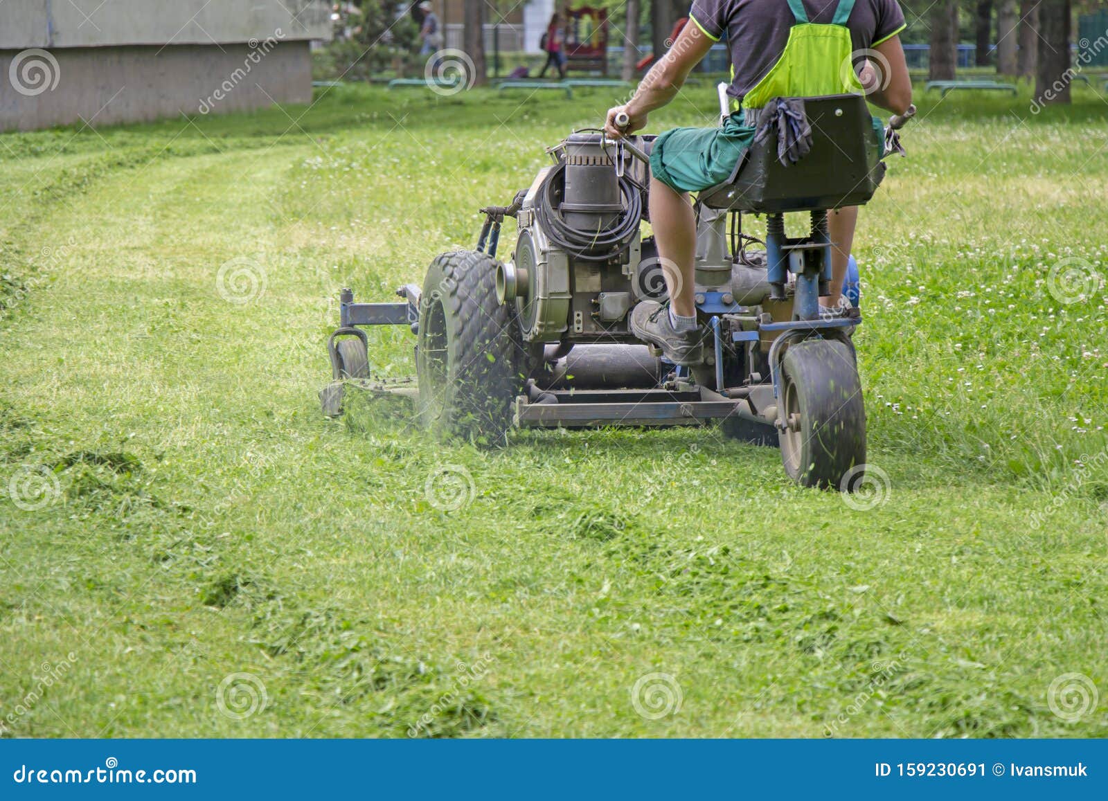 Worker Mowing Grass in City Park Stock Image - Image of ground, cutting ...