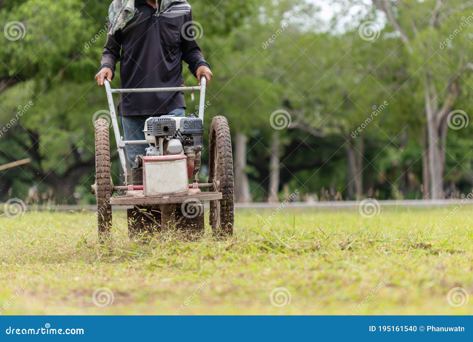 Worker Mowing Grass with Machine in the Public Garden Stock Photo ...
