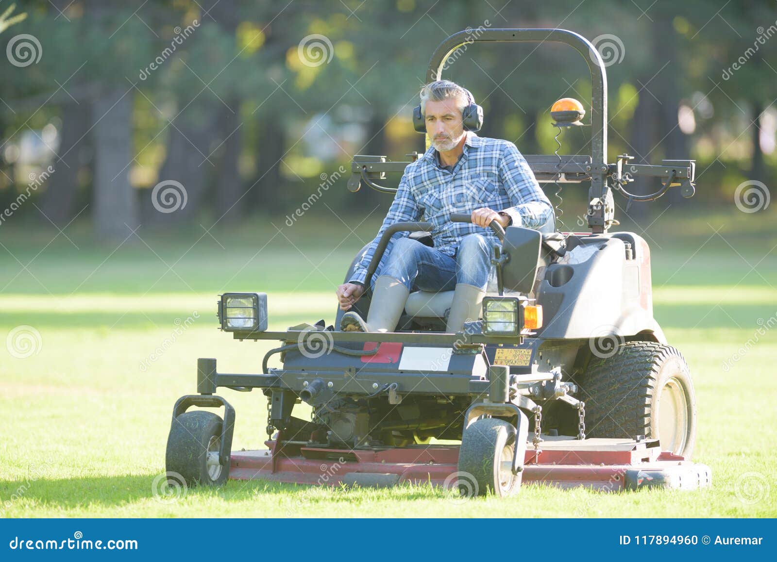 Worker mowing the park stock photo. Image of area, park - 117894960