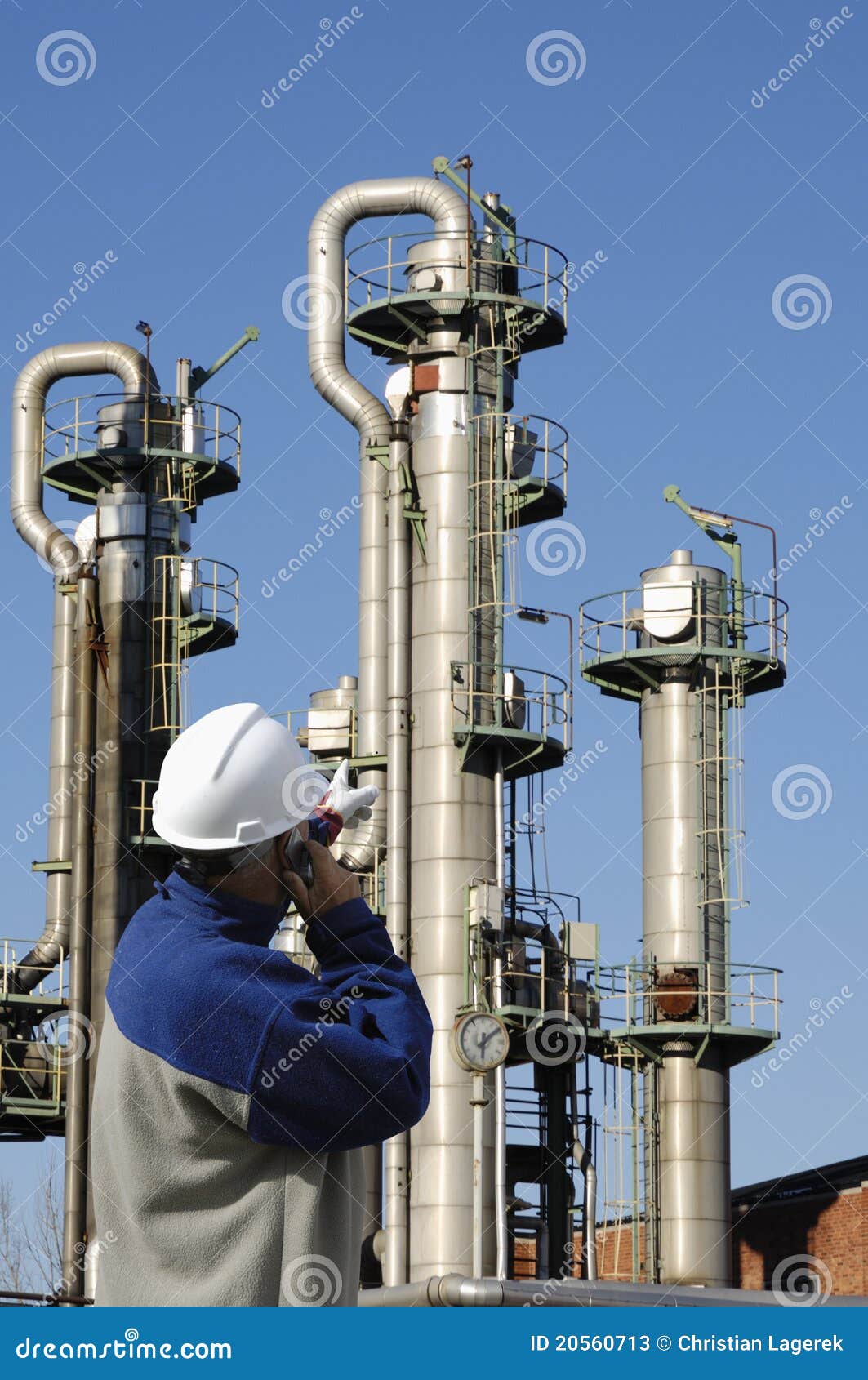 Worker and oil towers stock image. Image of energy, factory - 20560713