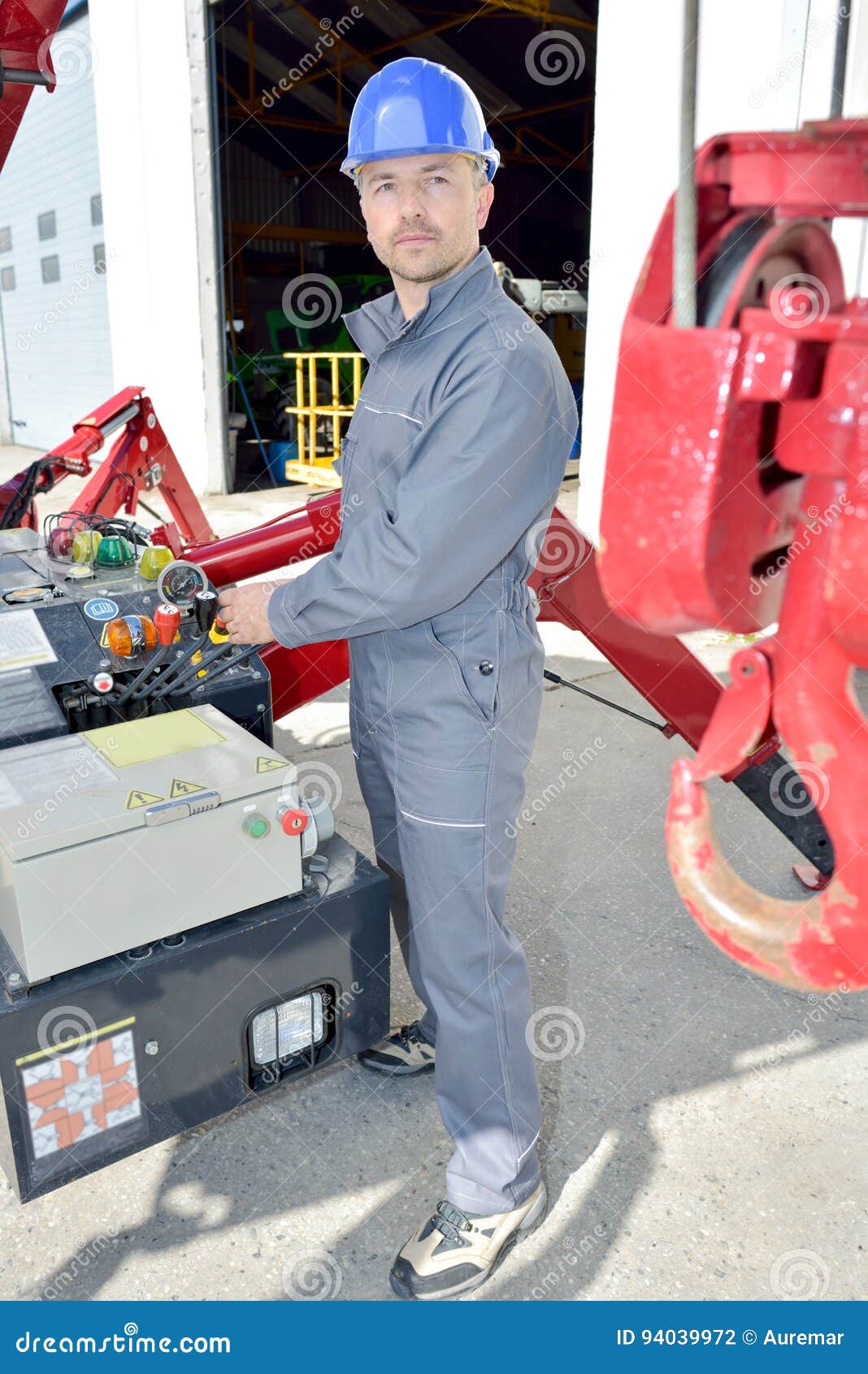 Worker Operating Crane at Construction Site Stock Photo - Image of ...
